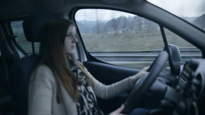 Stock Video Clip of Woman in car driving through countryside landscape ...