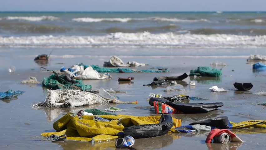 Pan Close Up Shot Of Trash And Rubbish On Sand Of Seashore On Sea ...
