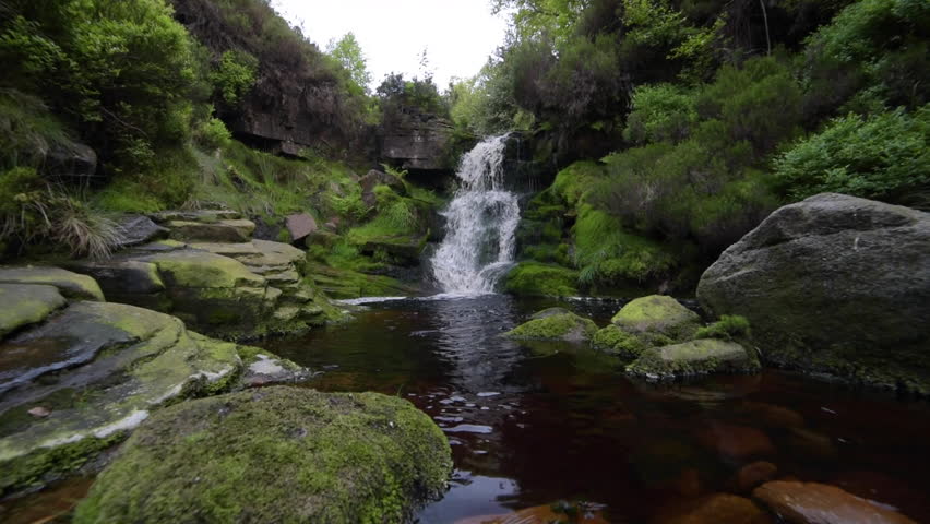 Stock Video Clip of Beautiful waterfall in a green valley in | Shutterstock