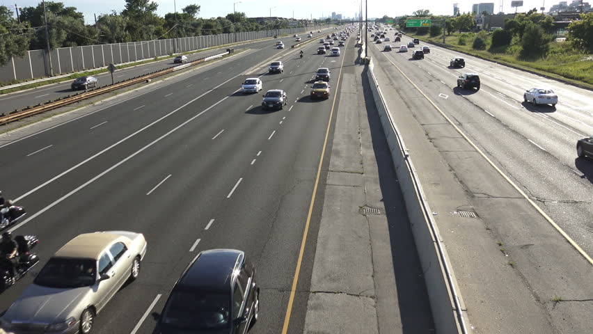 Vehicles Traveling On Queen Elizabeth Way (QEW) In Toronto, Canada. The ...