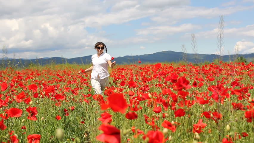 Beautiful Woman Walking Among Blooming Poppy Flowers. Beautiful Woman ...