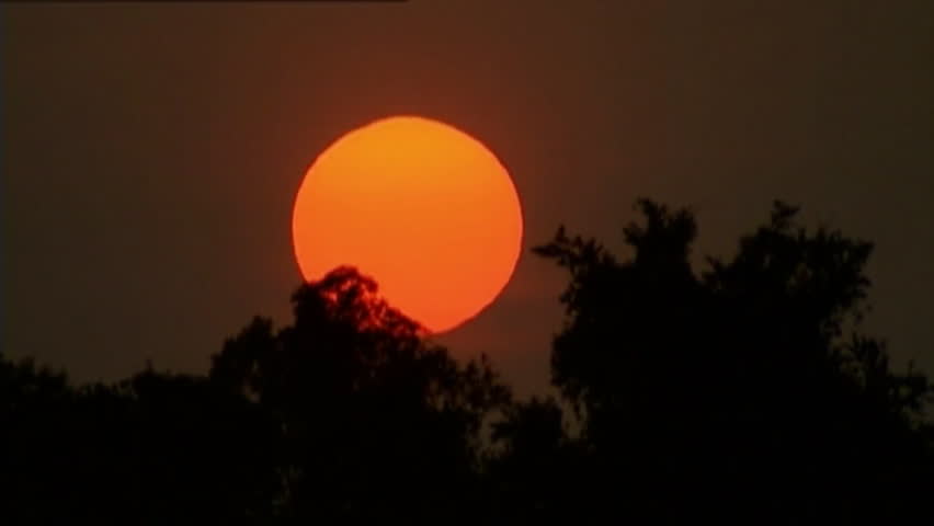 Big, Red Fireball Sun Sinking Into Purple Sky At Sunset At Oyster Bay ...