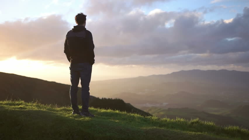 Back View Of Young Man Looking At Sun In Nature Mountain Outdoor At ...
