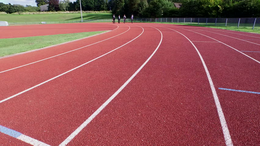 4K Drone Footage Of Track Athletes Crossing Finish Line At Running ...