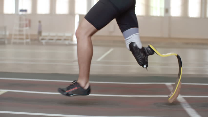 Follow Shot Of Paralympic Amputee Athlete With Prosthetic Leg Running ...