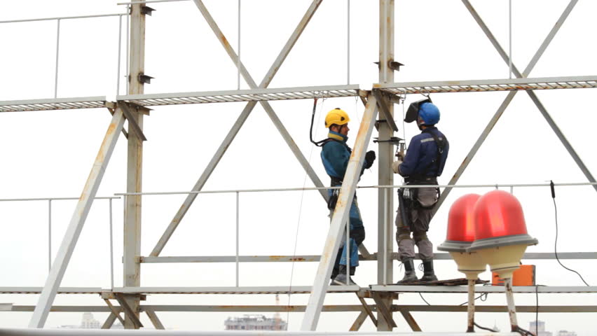 High-Altitude Work. The Man In Special Clothes And Helmet Holds The ...