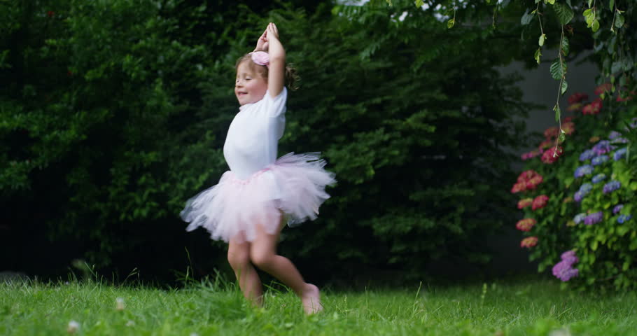 New Baby Tries To Take The First Steps In A Garden Dressed As A Little ...