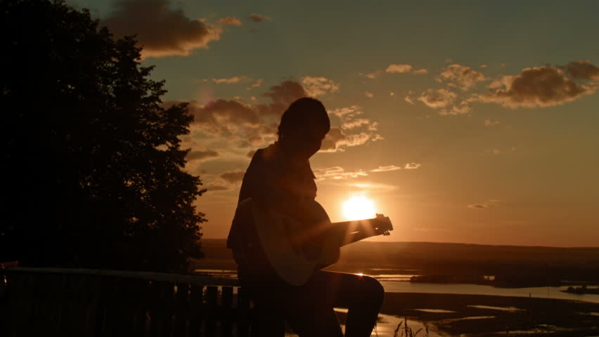 Attractive Romantic Girl Playing The Acoustic Guitar, At Sunset Near ...