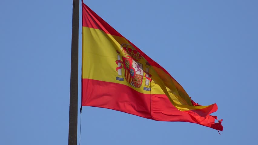 Spanish Flag Flying On A Flagpole Against The Blue Sky Stock Footage ...