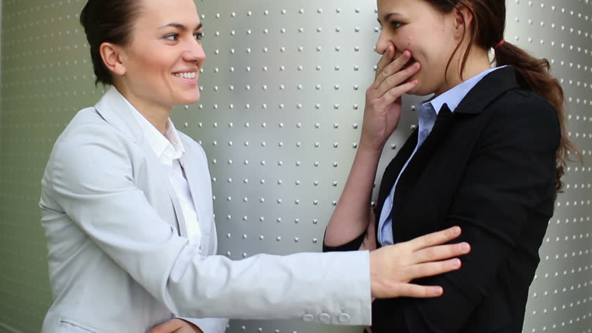 Stock Video Clip of Two woman gossip in the office, camera | Shutterstock