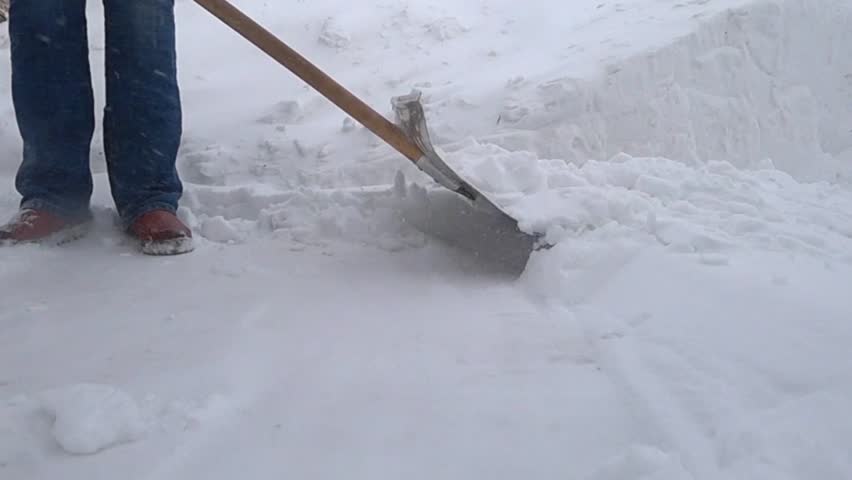 In This Video, We Can See That A Man Is Throwing A Spade Of Snow Onto A ...