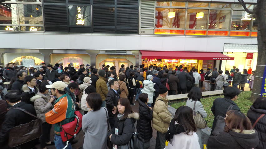 TOKYO, JAPAN - DECEMBER 20, 2016: Crowds Of People Queue Up To Buy ...