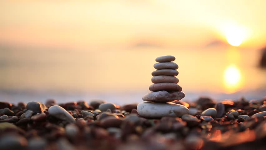 A Stacked Pile Of Rocks On A Calm Ocean Beach Suggests Zen, Peace And ...