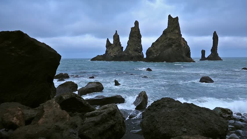 Stock Video Clip of Dramatic seascape of Reynisdrangar cliffs in the ...