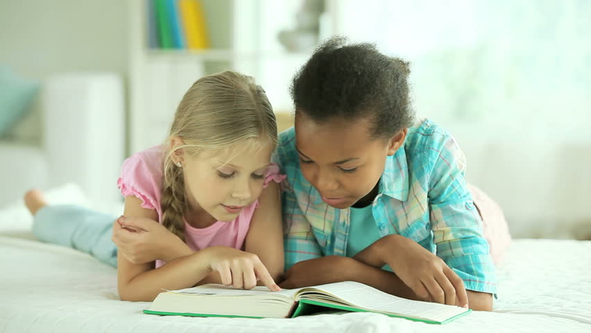 Two Schoolgirls Using Laptop To Communicate With Their Friends Stock ...