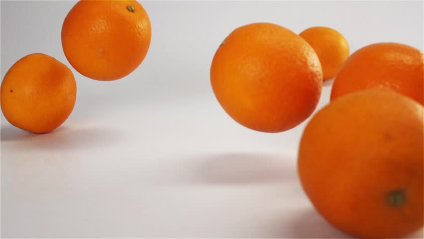 Many Orange Balls Falling And Bouncing Over The White Surface Slow ...