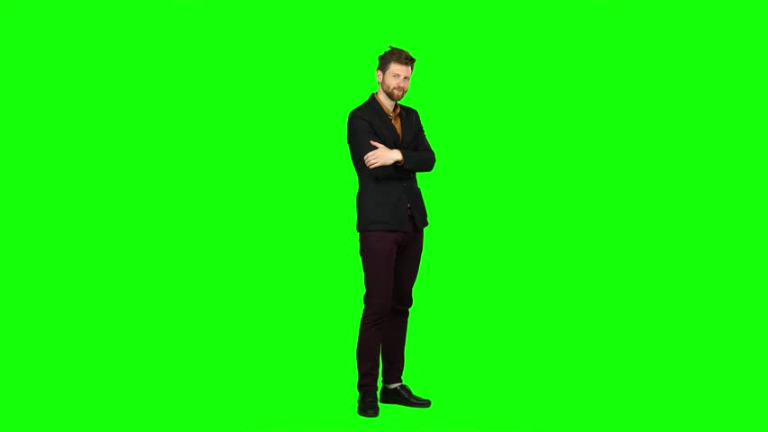 Portrait Of Young Man Standing Against Green Screen. Male Person People ...