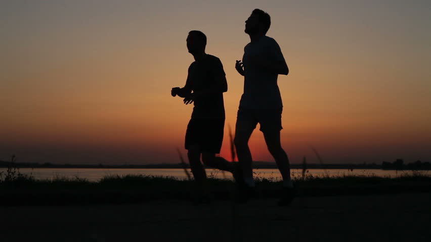 Stock video of two men jogging on lake shore | 28885009 | Shutterstock