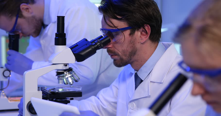 Medical Researchers Working In Hospital Laboratory Using Modern Sterile ...