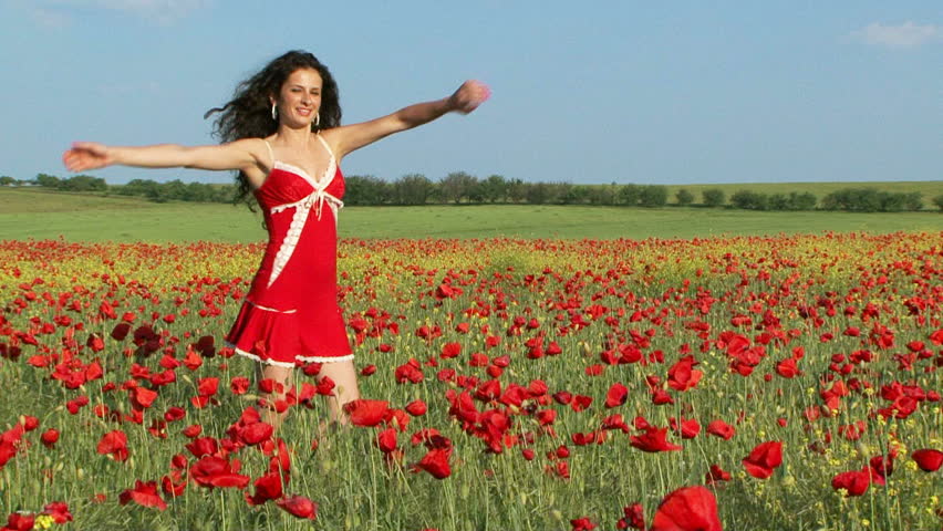 Beautiful Woman Walking Among Blooming Poppy Flowers. Beautiful Woman ...