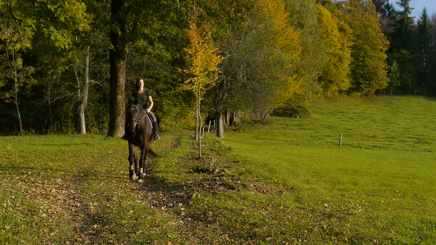 Stock video of young woman horseback riding in nature | 3584309 ...