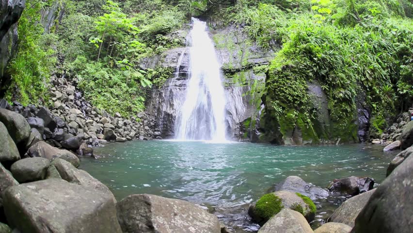 A Gorgeous Waterfall Drops Into A Natural Pool On Cocos Island, Costa ...