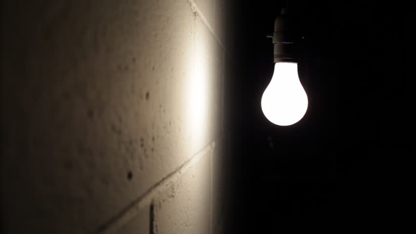 Light Bulb Swaying Against Wall In Dark Room Stock Footage Video ...
