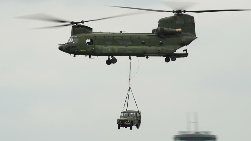 A Chinook CH-47 Helicopter Fly By With An Apache AH-64 In The ...