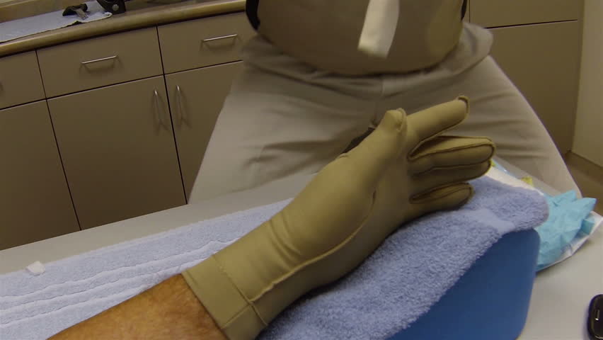 Stock Video Clip of Doctor putting compression bandage on patient arm ...