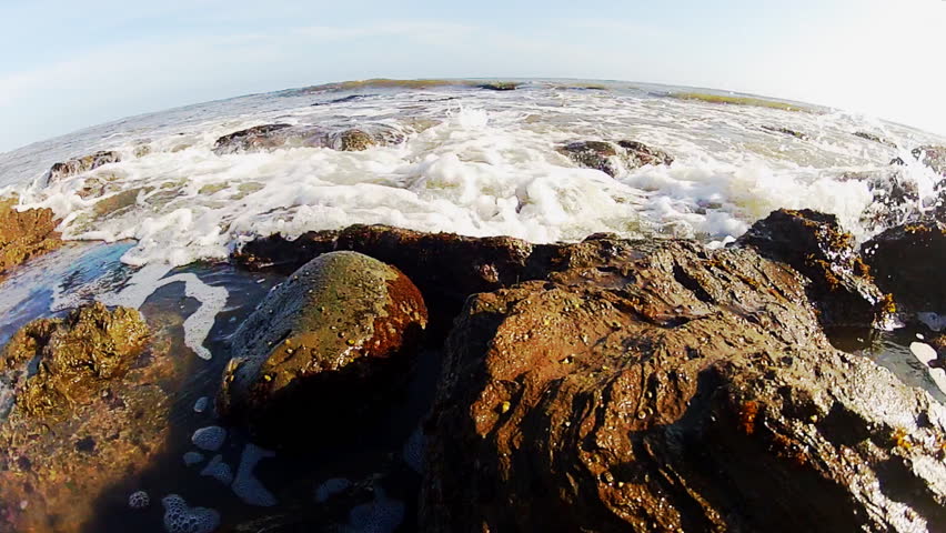 Waves washing over rocks on the shoreline image - Free stock photo ...