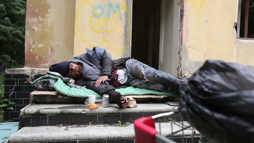 Homeless Man Sleeping In The Open Air On The Porch Of An Abandoned ...