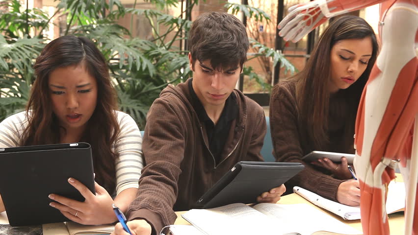 A Group Of College Students Work Together To Finish An Assignment Stock ...