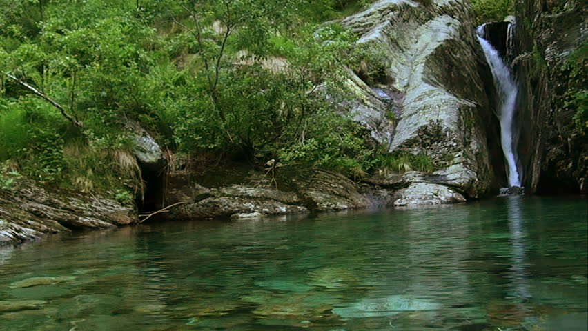 Stock video of mountain lake with little waterfall flowing | 5027759 ...