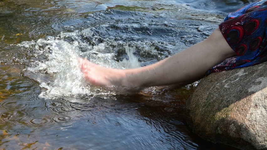 Stock Video Clip of woman bare feet immersed in a fast | Shutterstock