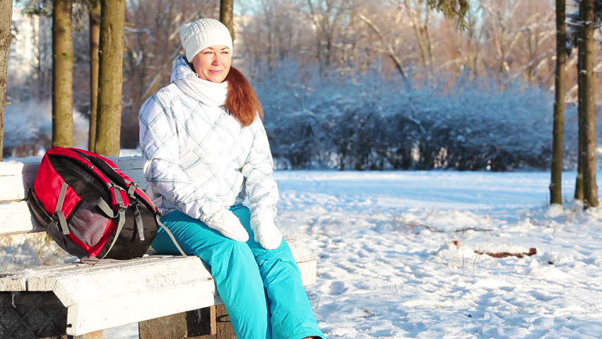 Young Woman Sitting On A Park Bench Surrounded By Snow Stock Footage ...