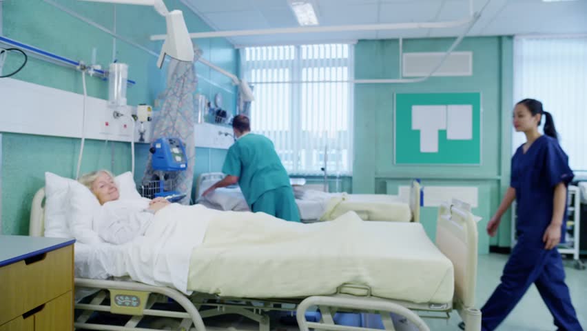 Two Patients Are Visited By Their Medical Teams Who Chat To Them And ...