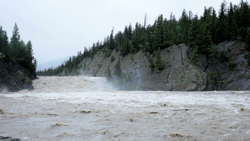 Stock video of fast flowing river carrying flood water | 5972129 ...