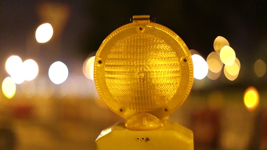 A Caution Sign Is Lit Up By A Blinking Yellow Warning Light Stock ...