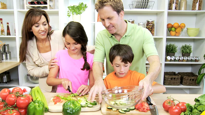 Smiling Family Preparing A Healthy Dinner Together At Home In The ...