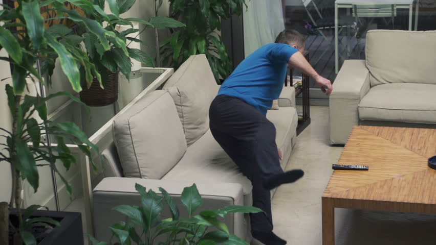 Man Jumping, Relaxing On Sofa Stock Footage Video (100% Royalty-free ...