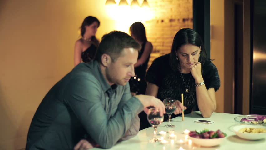 Stock video of bored young couple during bad date | 6624539 | Shutterstock