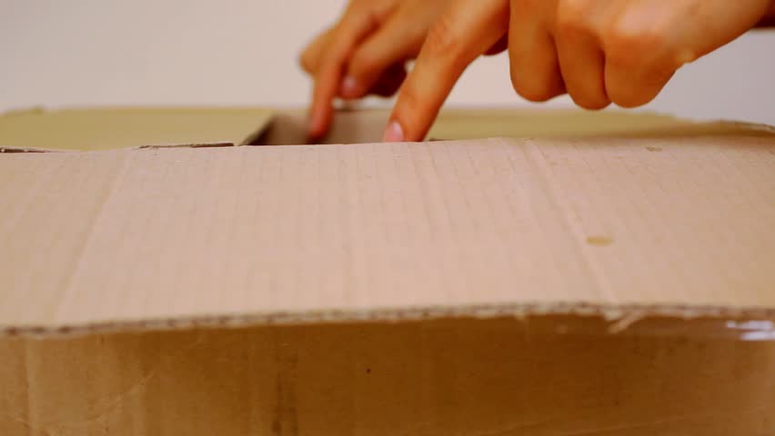 Stock Video Clip of Close up female hands open cardboard box ...