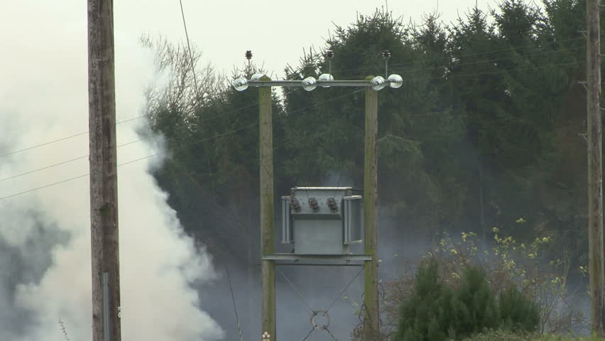 Smoke Rises Behind A High Voltage Electricity Transformer. Vídeo stock ...