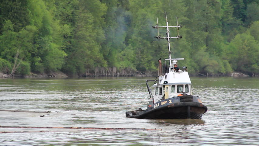 A Logging Boom Boat Is Moored Alongside A Fast Moving River/Boom Boat/A ...