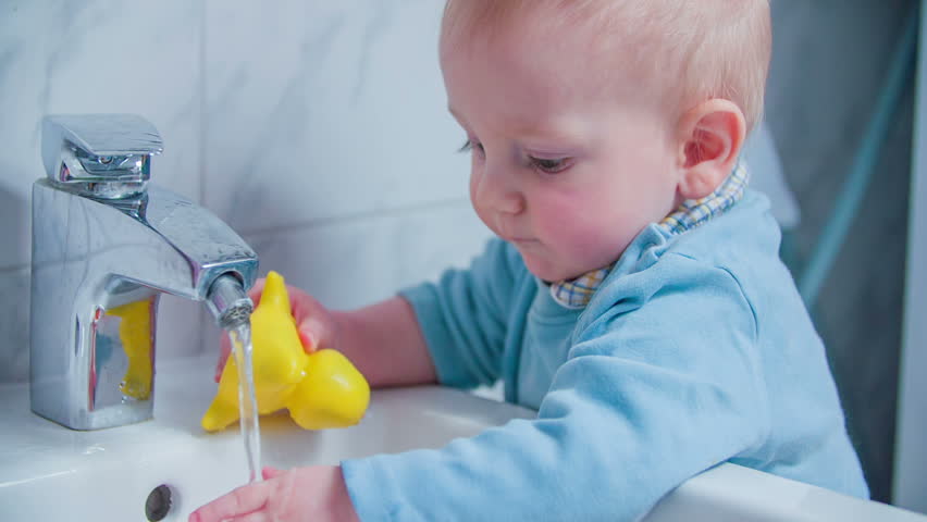 Stock video of child playing in bidet. cute small | 9996719 | Shutterstock